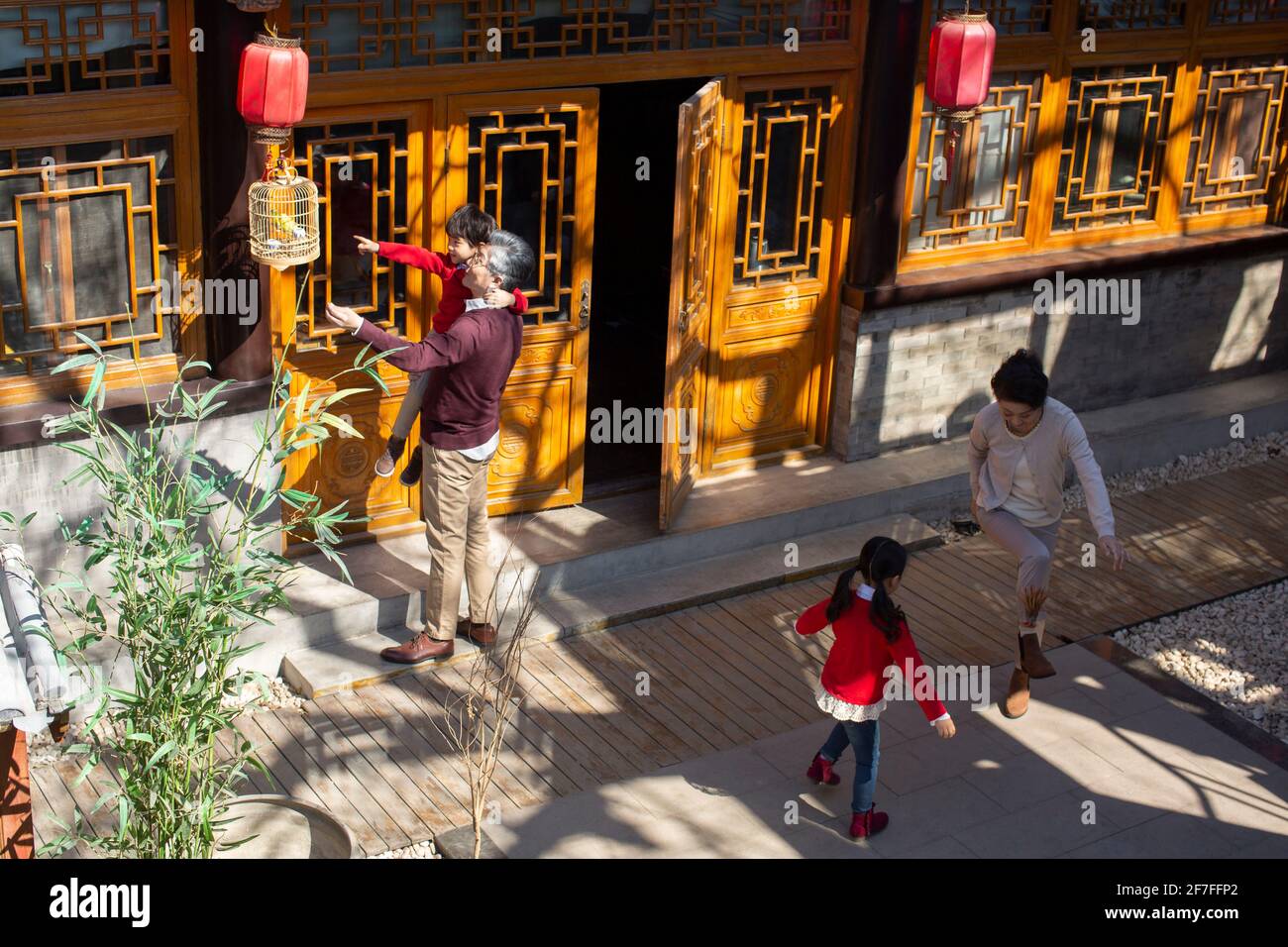 Happy family having fun in yard Stock Photo - Alamy
