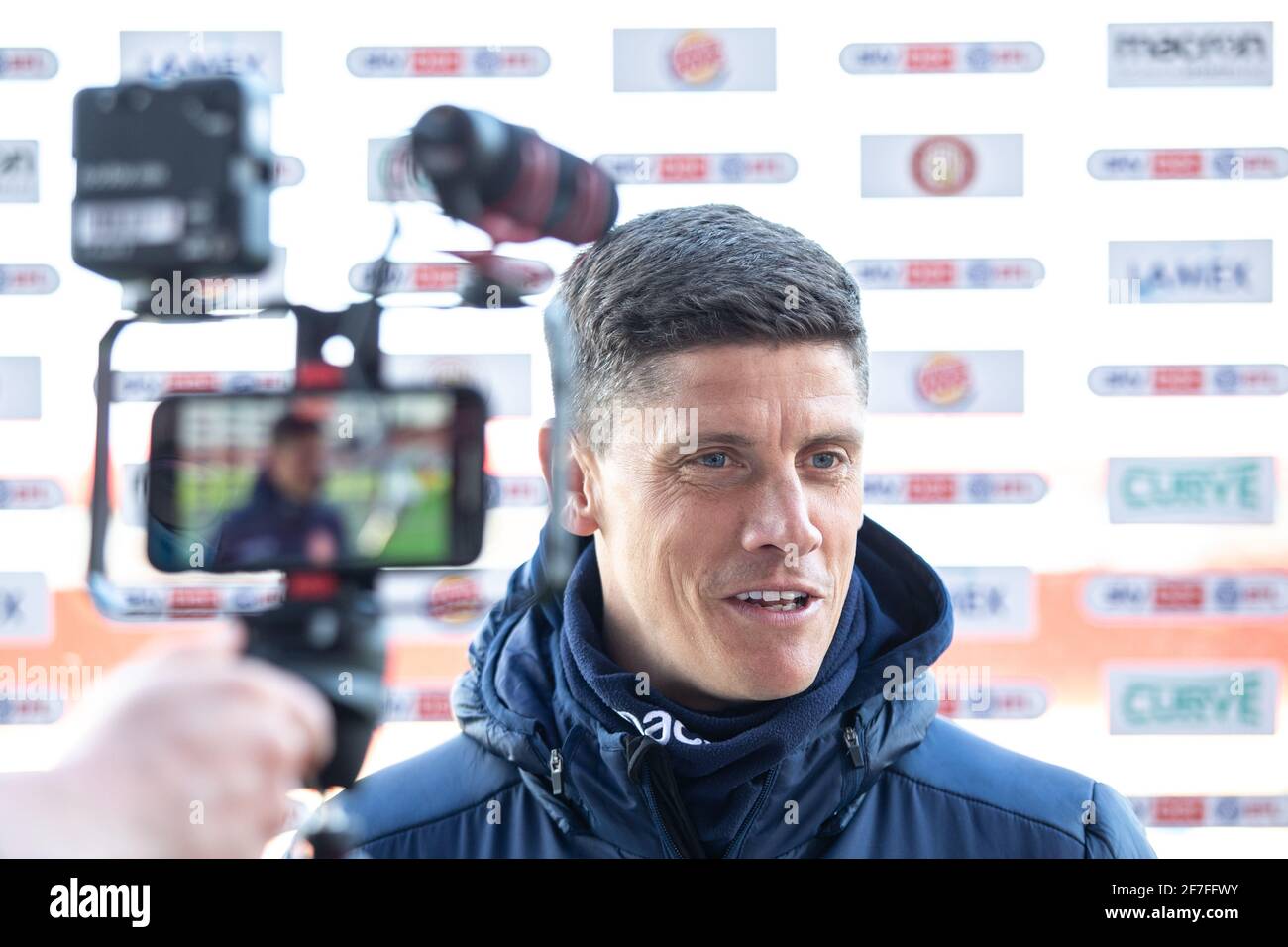 Football manager Alex Revell filmed and interviewed by journalists post ...