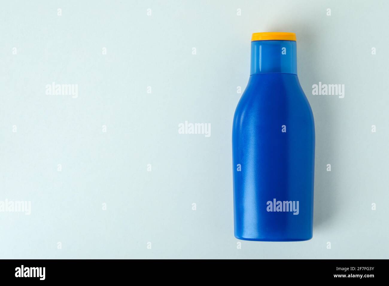 Blank blue bottle of sunscreen on white background Stock Photo - Alamy