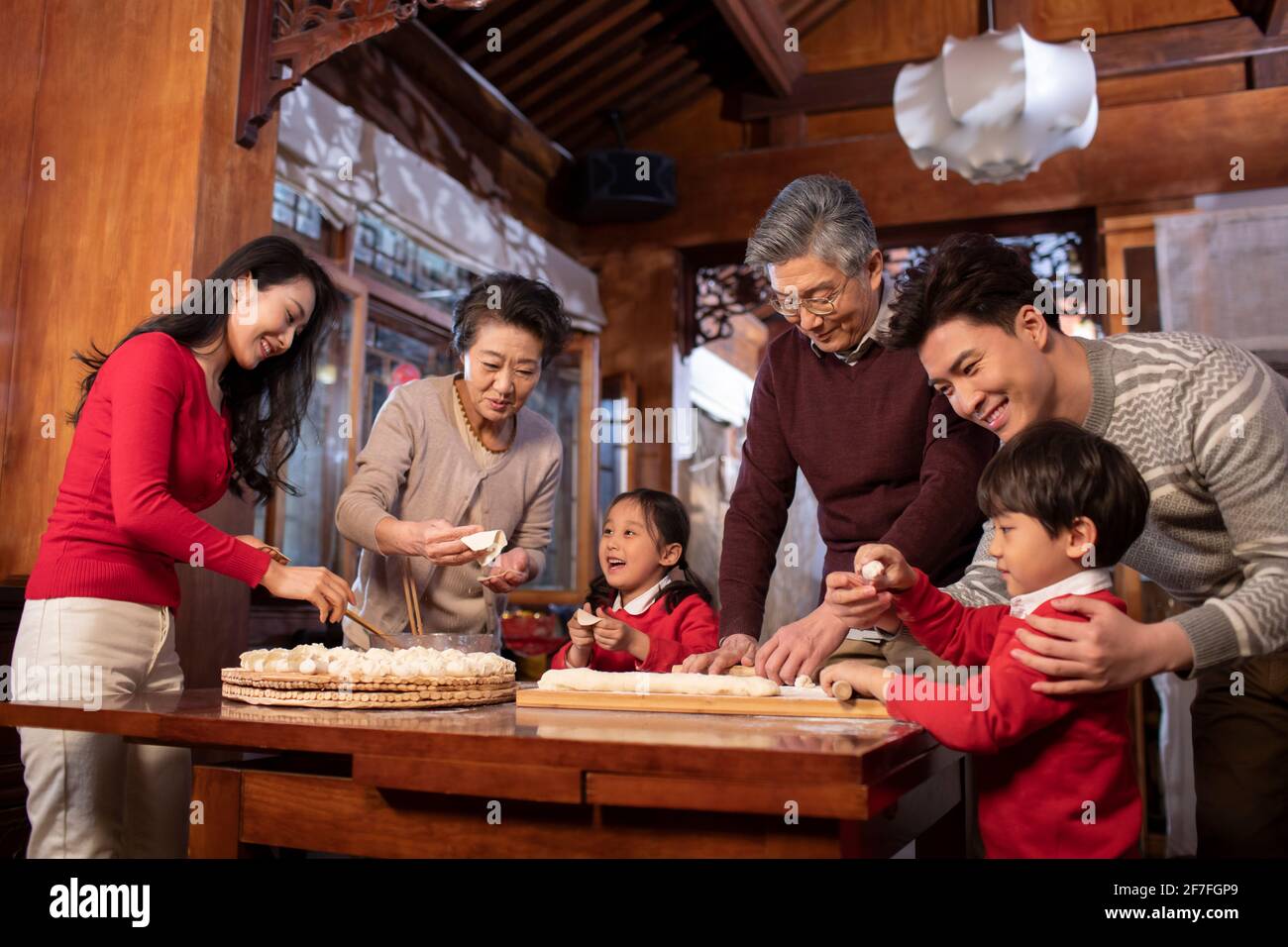 Happy family making dumplings Stock Photo - Alamy