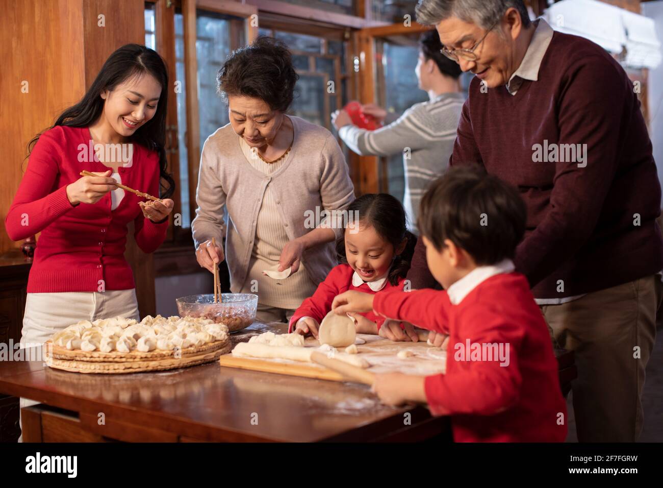 Happy family making dumplings Stock Photo - Alamy