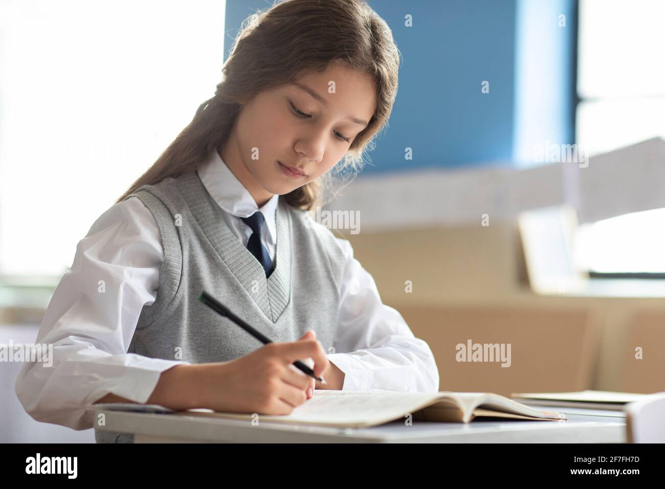 Little girl learning in classroom Stock Photo - Alamy