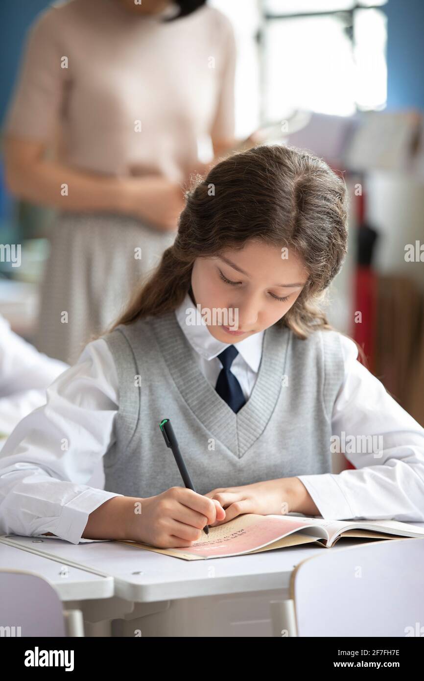 Little girl learning in classroom Stock Photo - Alamy