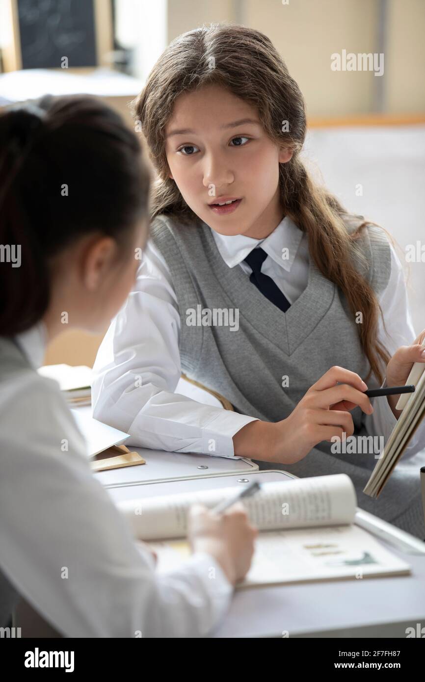 Two students talking classroom teenager hi-res stock photography and ...