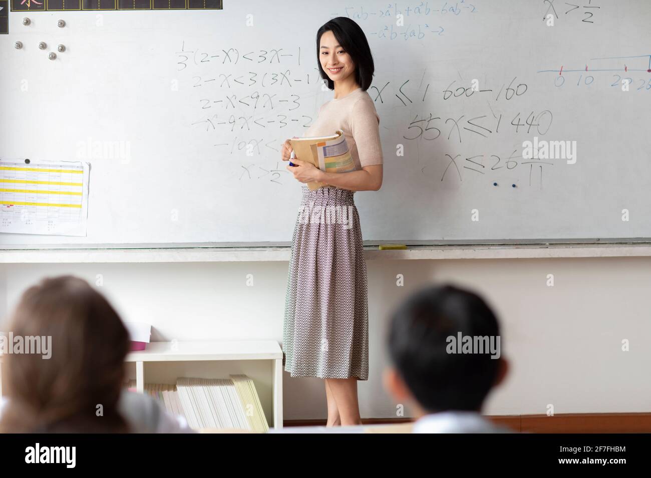 Young teacher teaching a class Stock Photo - Alamy