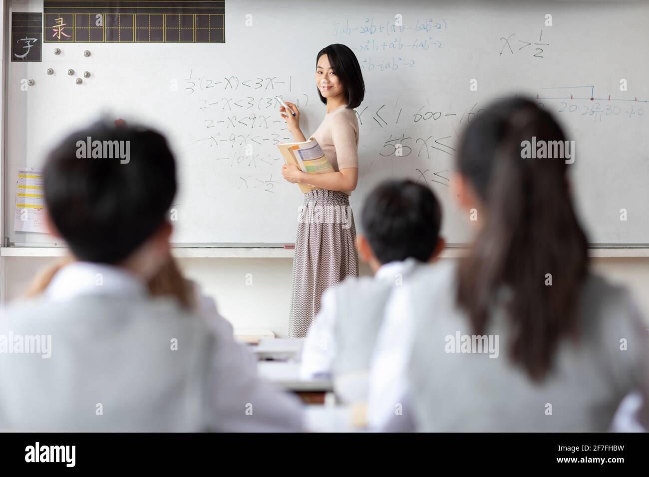 Young teacher teaching a class Stock Photo - Alamy