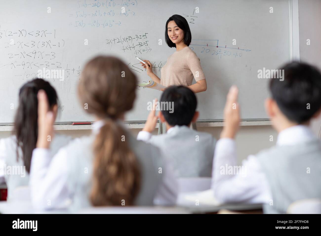 Young teacher teaching a class Stock Photo - Alamy