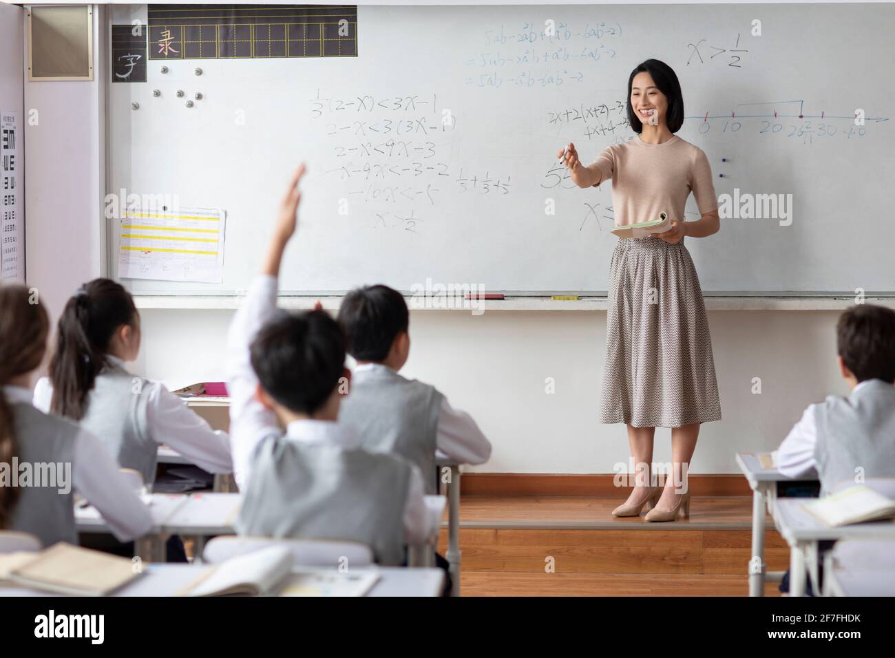 Young teacher teaching a class Stock Photo - Alamy