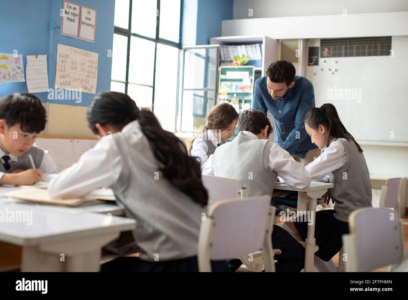 Young teacher teaching a class Stock Photo - Alamy