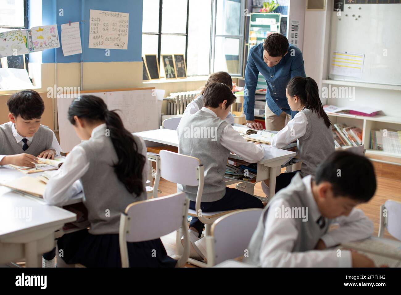 Young teacher teaching a class Stock Photo - Alamy