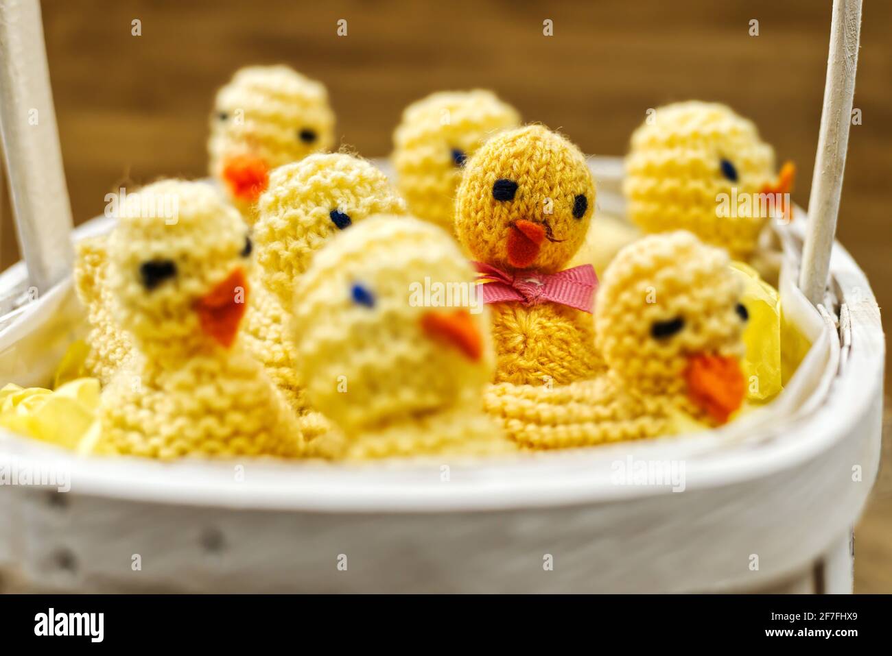 Cute knitted chicks containing chocolate eggs in an Easter basket Stock ...