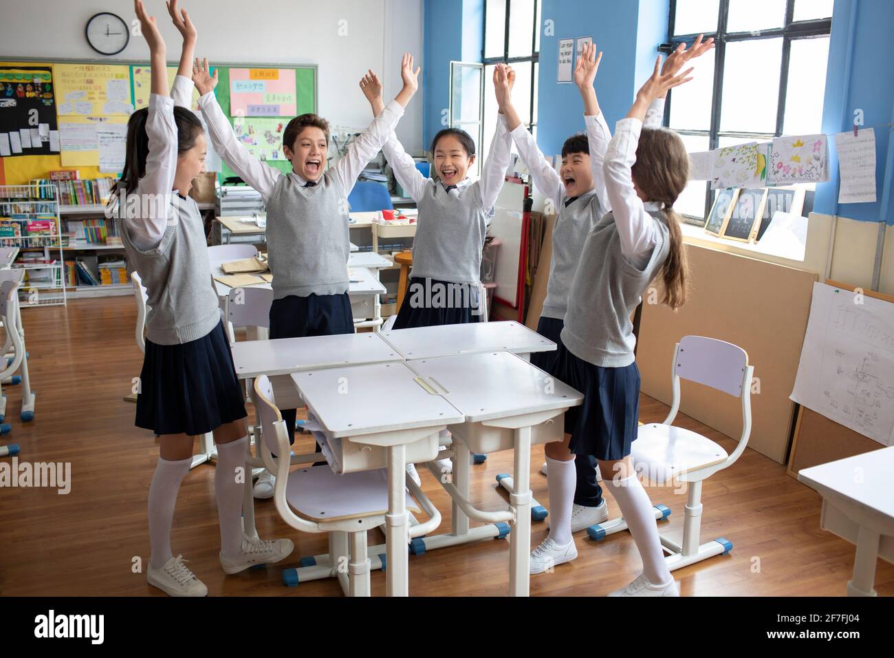 Classmates cheering in classroom Stock Photo - Alamy