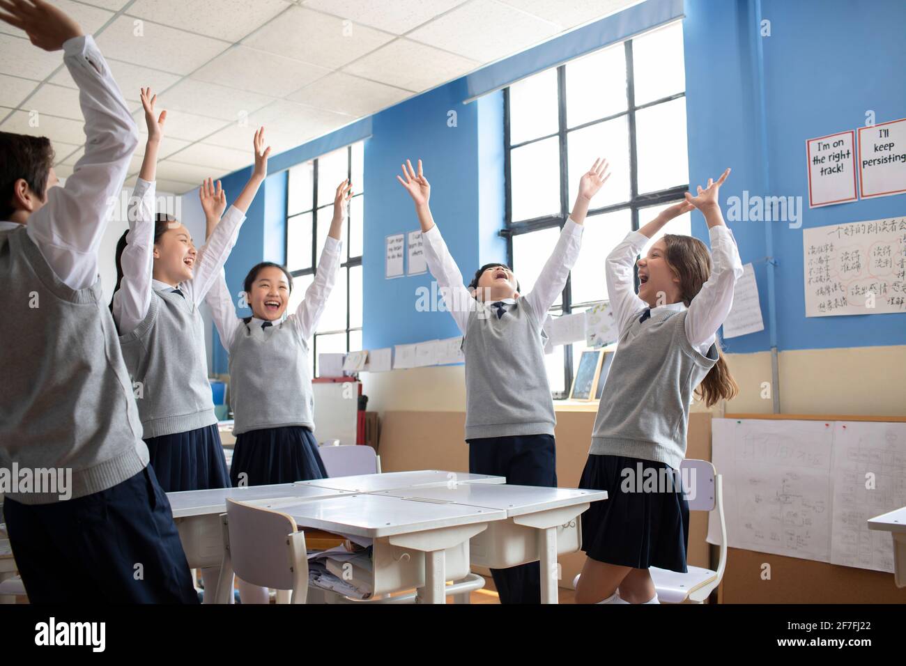 Classmates cheering in classroom Stock Photo - Alamy