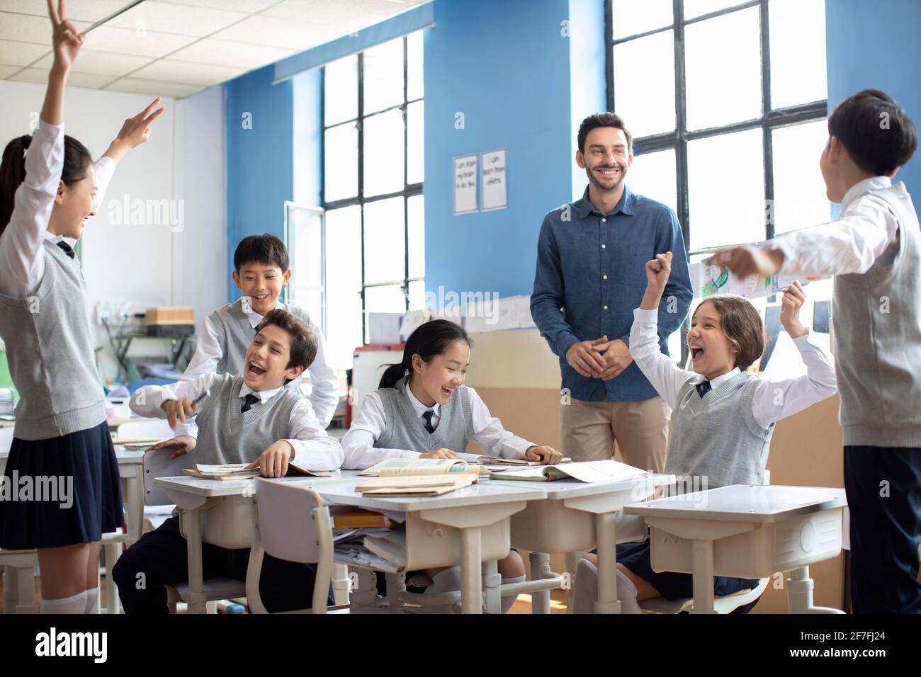Students cheering in classroom hi-res stock photography and images - Alamy