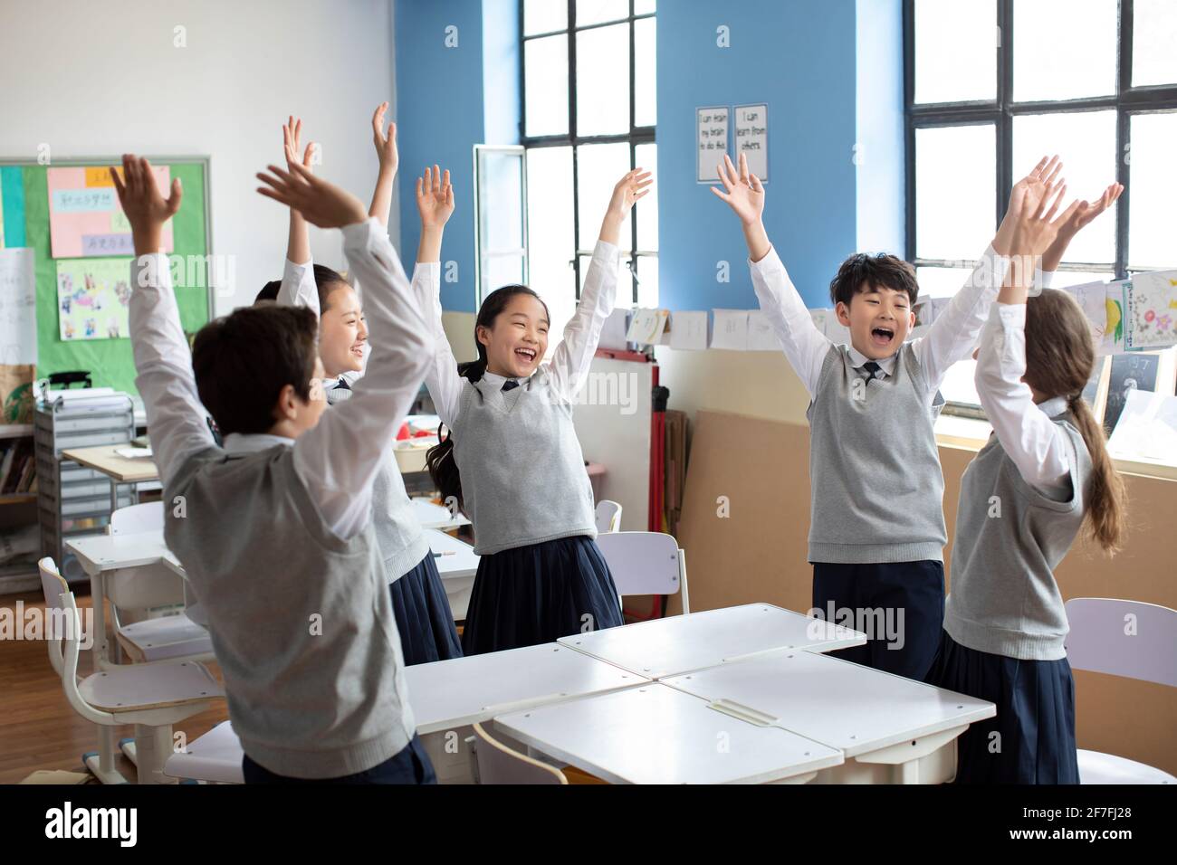 Classmates cheering in classroom Stock Photo - Alamy