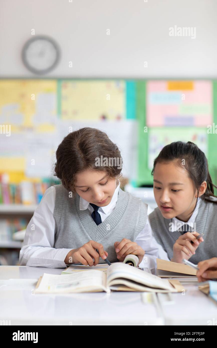 Classmates learning in classroom Stock Photo - Alamy