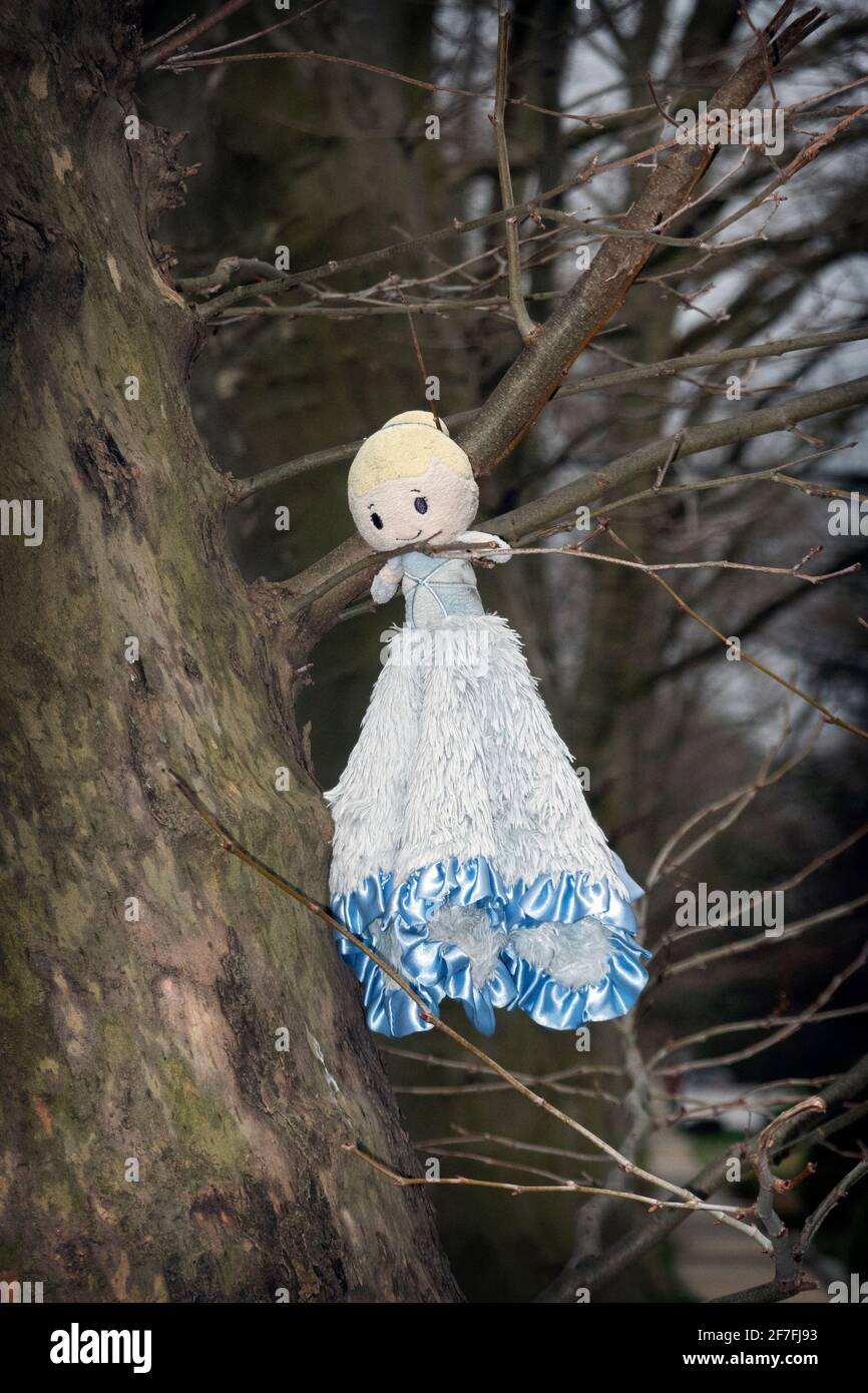 A sad faced puppet hanging from a bare tree. In Queens, New York City ...
