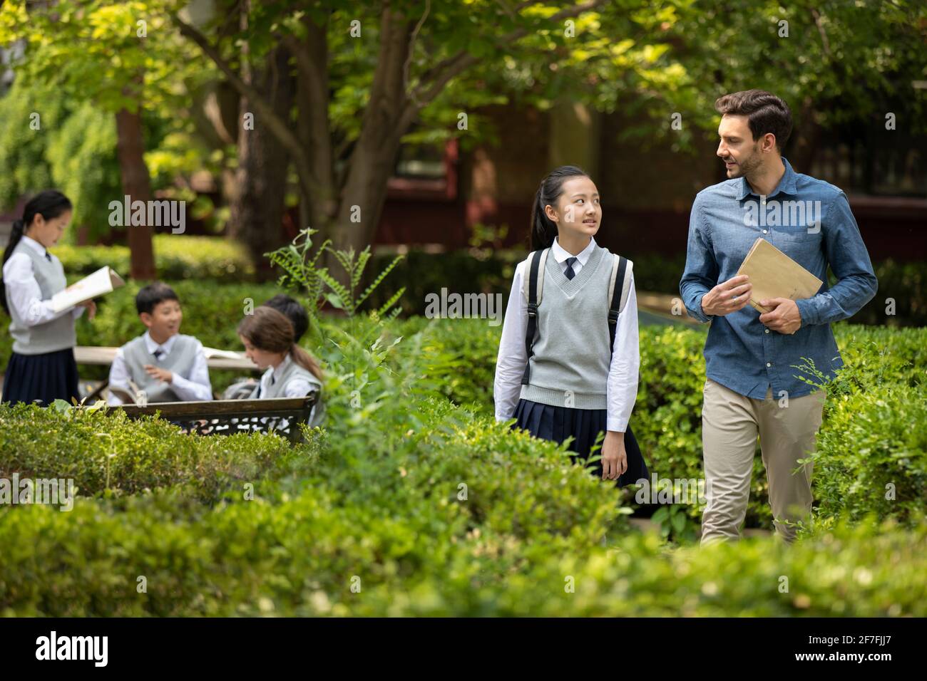 Teacher and students on campus Stock Photo - Alamy