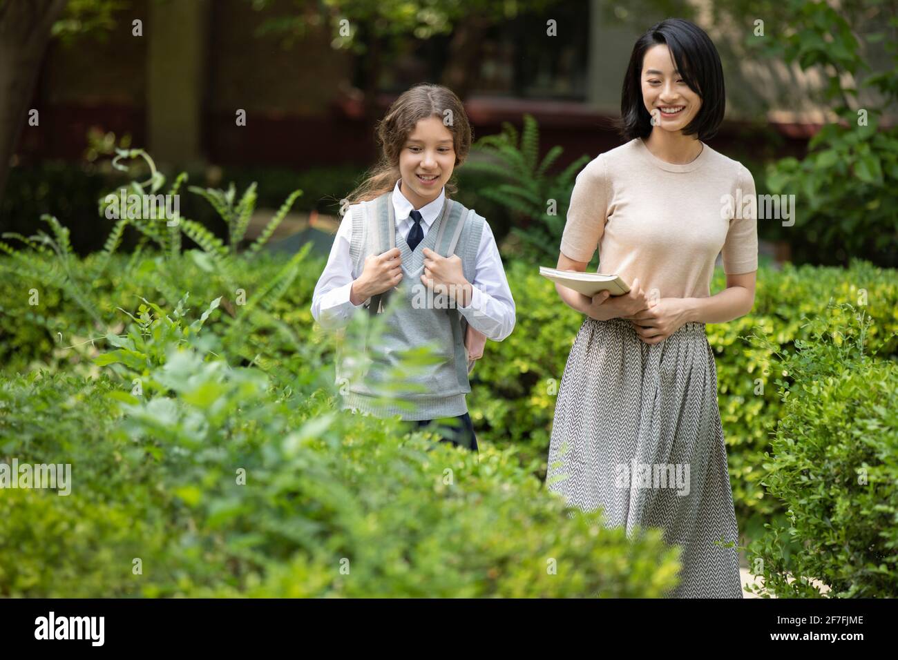Teacher talking with student on campus Stock Photo - Alamy