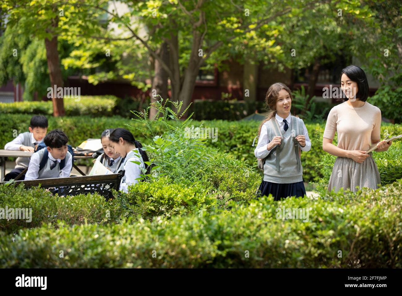 Teacher and students on campus Stock Photo - Alamy