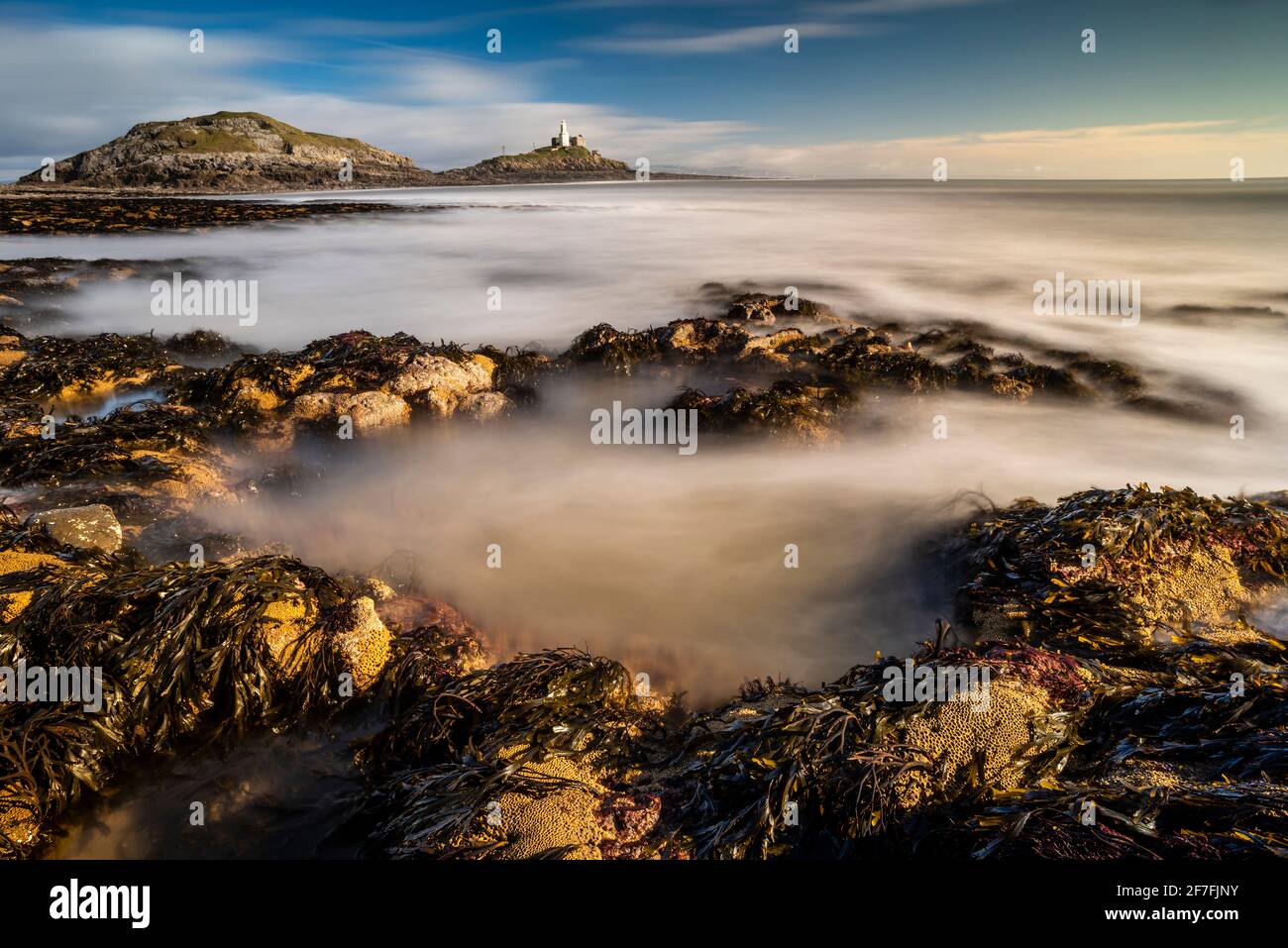 Tidal rock pools and Mumbles Lighthouse, Bracelet Bay, Mumbles Head ...