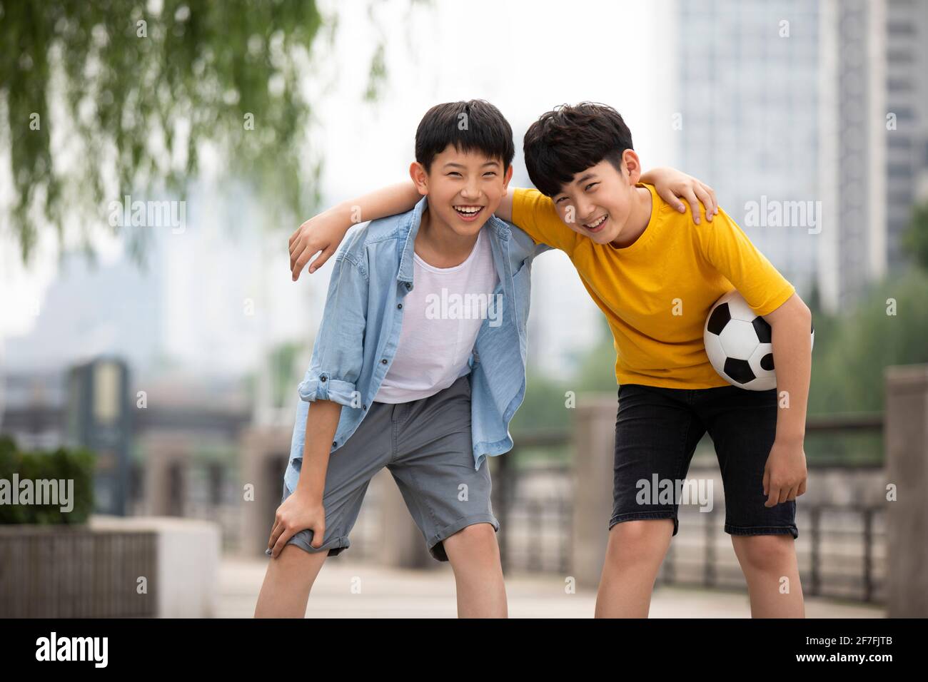 Boys playing football outdoors Stock Photo - Alamy