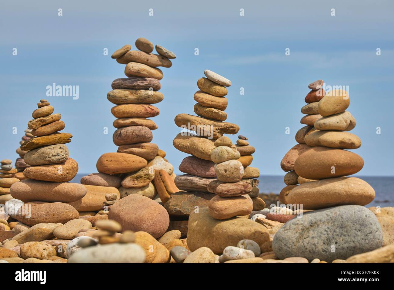 Stone trolls piled up on the shore at Lindisfarne, Holy Island ...