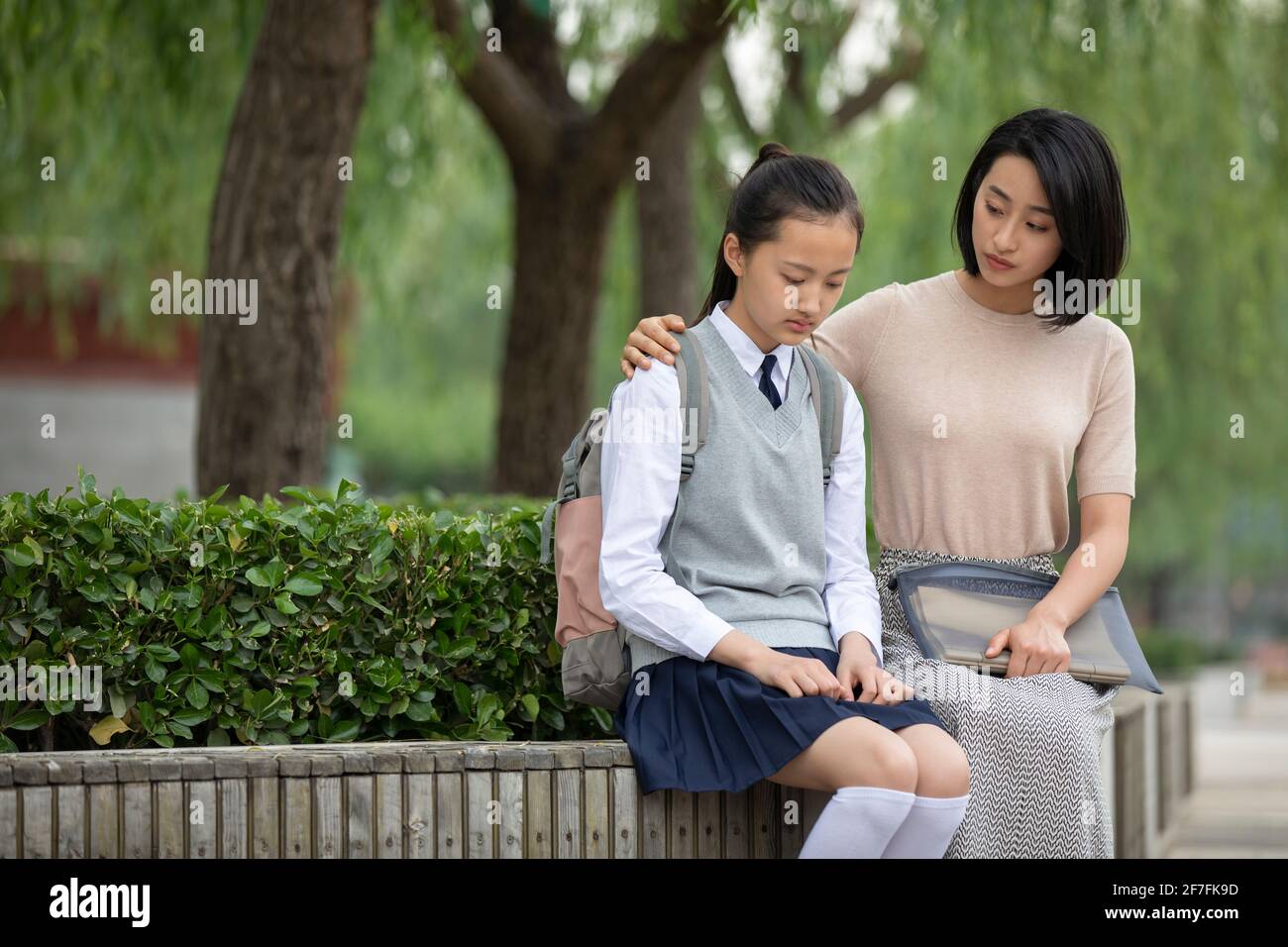 Teacher consoling student Stock Photo - Alamy