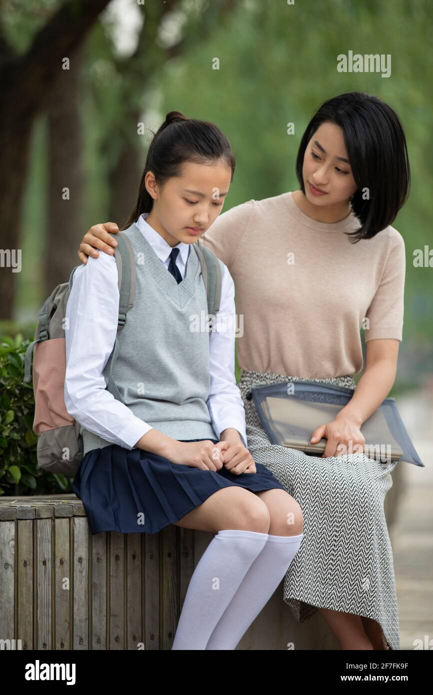Teacher consoling student Stock Photo - Alamy