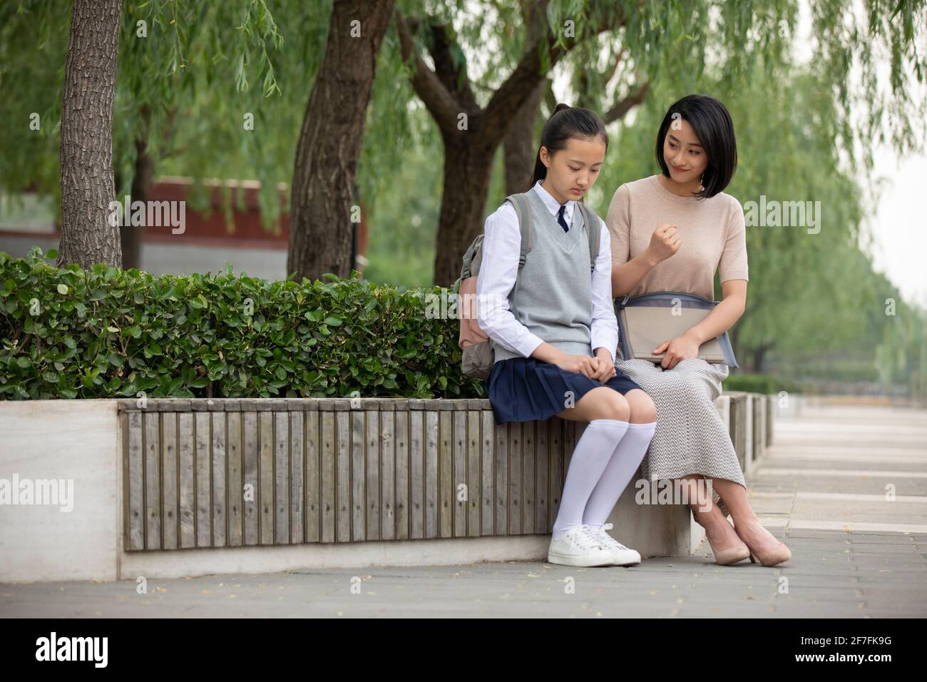 Teacher consoling student Stock Photo - Alamy