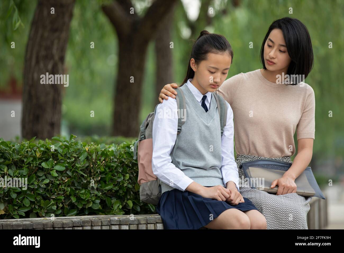 Teacher consoling student Stock Photo - Alamy