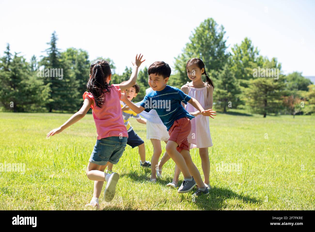 Happy children playing games on meadow Stock Photo - Alamy