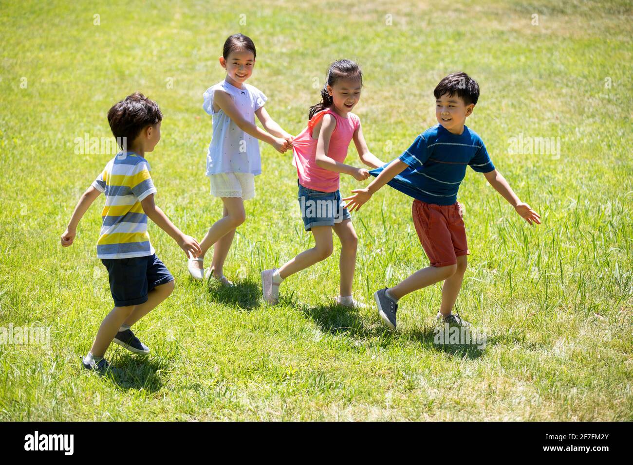 Happy children playing games on meadow Stock Photo - Alamy