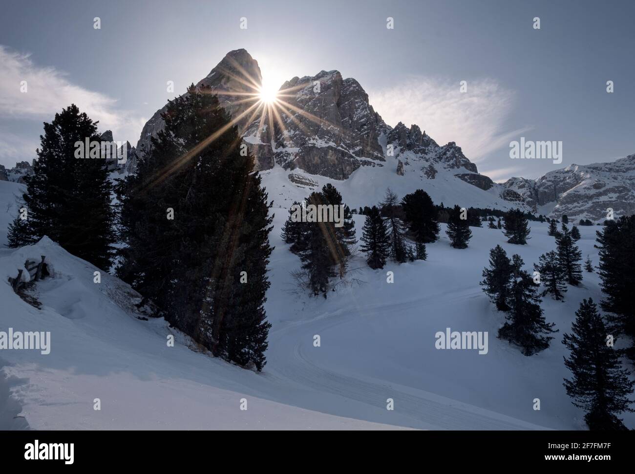 Dolomites snowy winter landscape of the Sass the Putia with a sun star ...