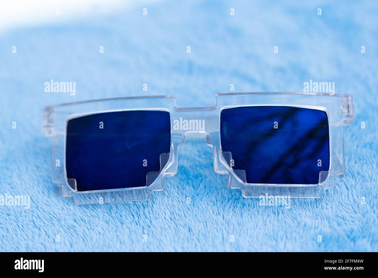 Blue lenses pixel sunglasses model shoot in a summer day closeup ...