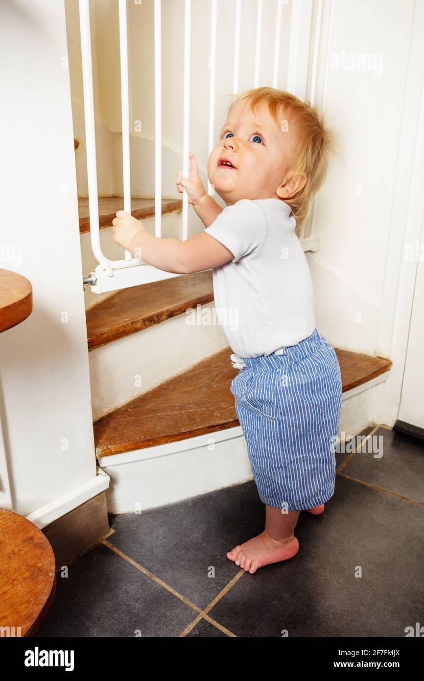 Toddler near stairs security safety guard gate Stock Photo - Alamy