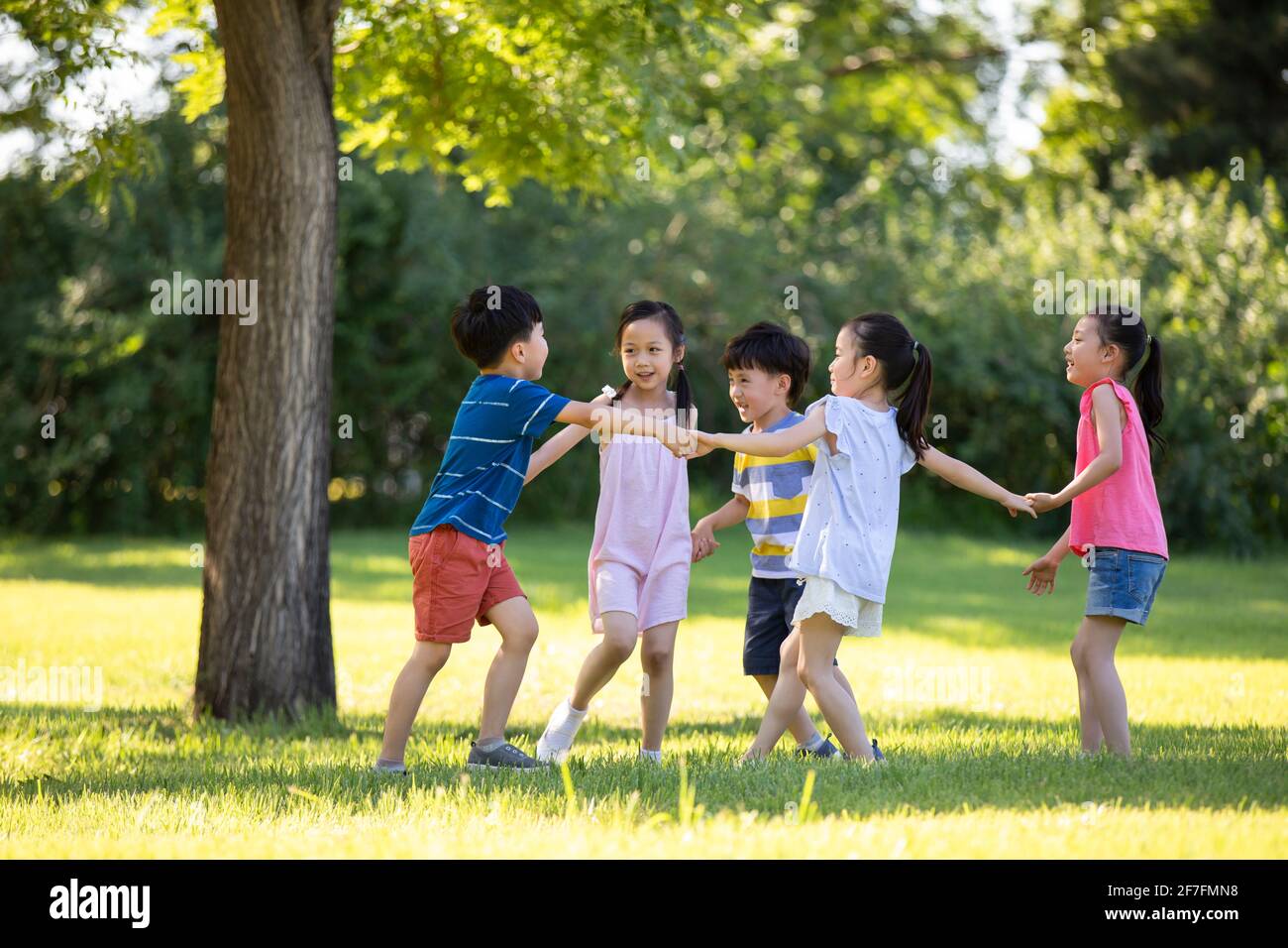 Happy children playing on meadow Stock Photo - Alamy
