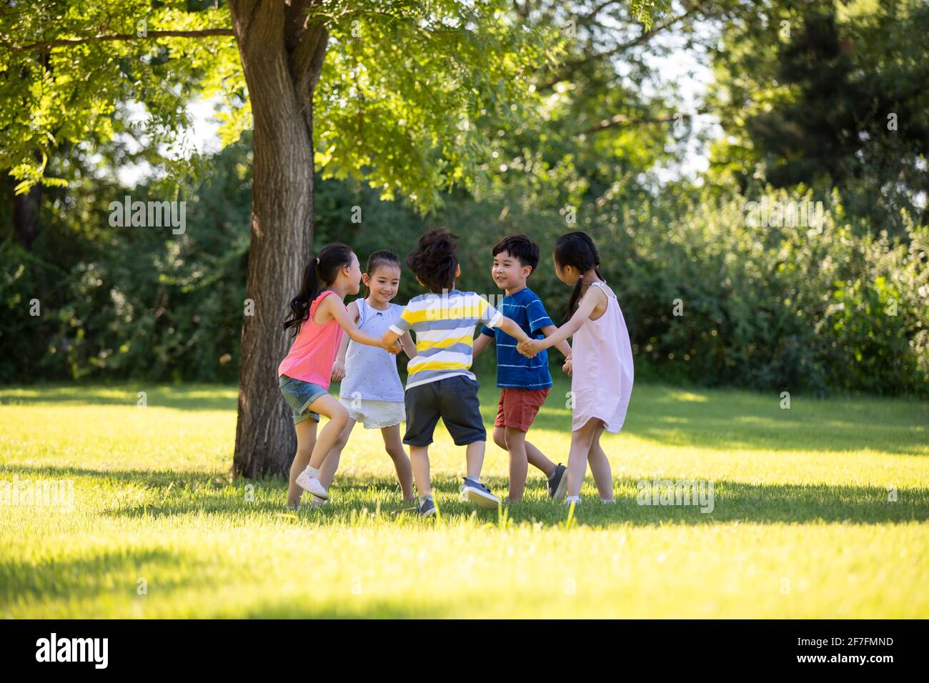 Happy children playing on meadow Stock Photo - Alamy
