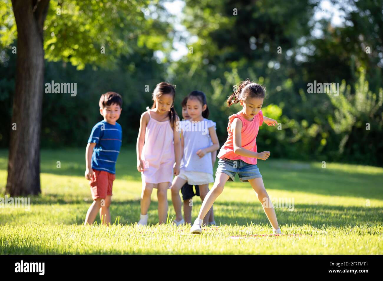 Happy children playing on meadow Stock Photo - Alamy