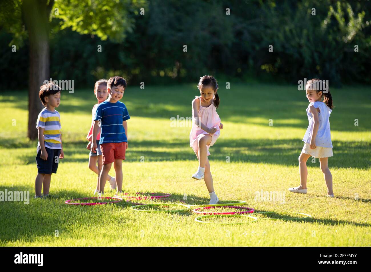 Happy children playing on meadow Stock Photo - Alamy