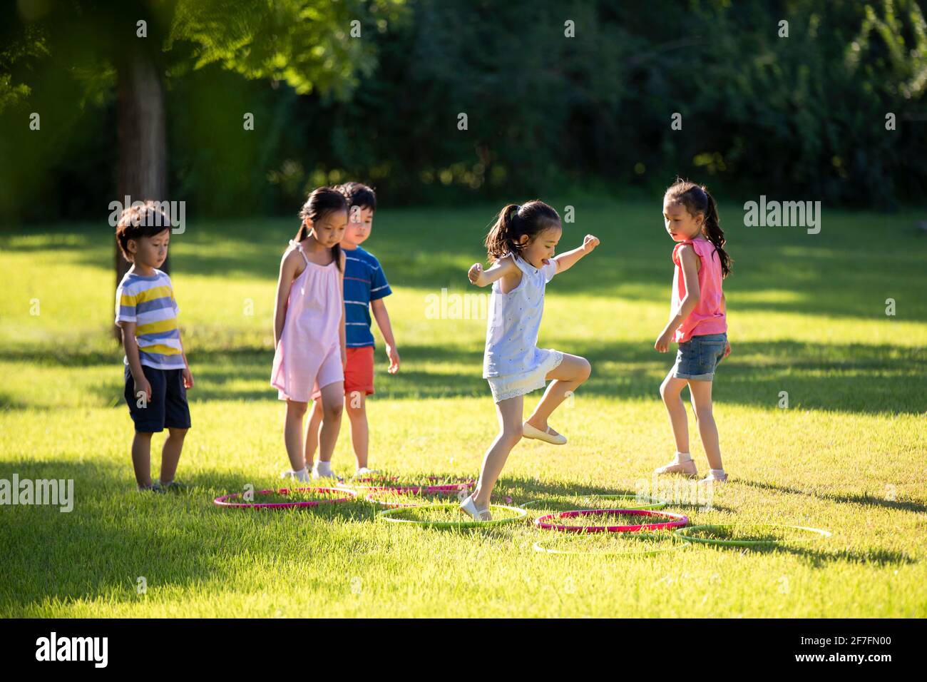 Happy children playing on meadow Stock Photo - Alamy