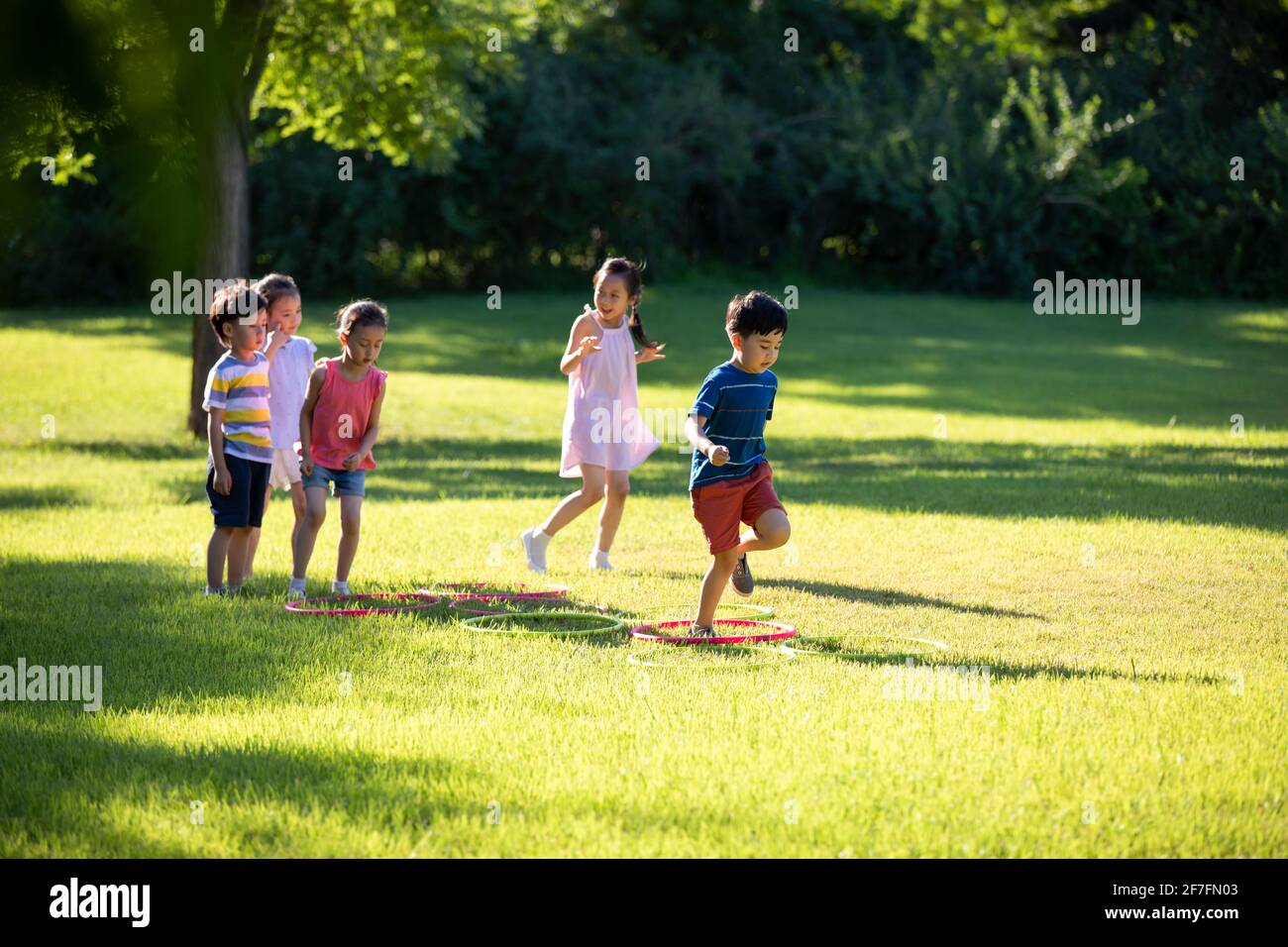 Happy children playing on meadow Stock Photo - Alamy