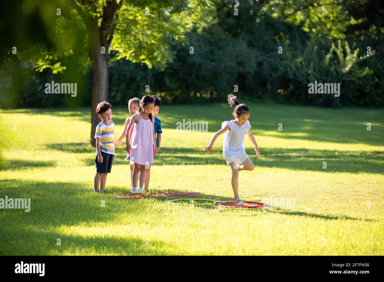 Happy children playing on meadow Stock Photo - Alamy