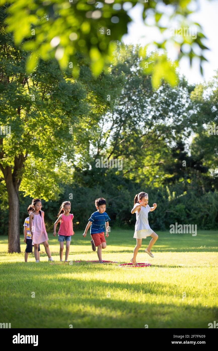 Happy children playing on meadow Stock Photo - Alamy