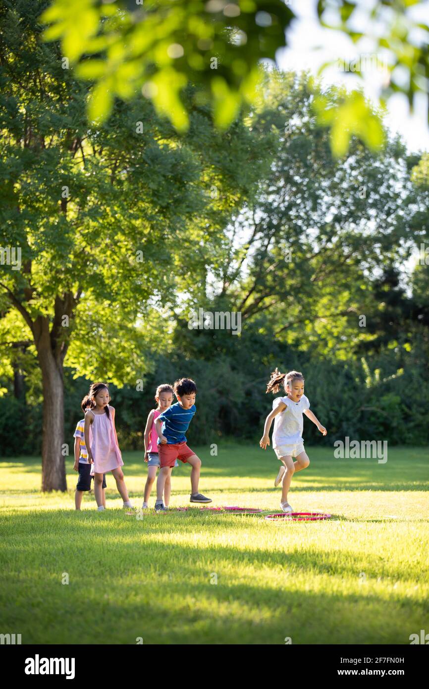 Happy children playing on meadow Stock Photo - Alamy