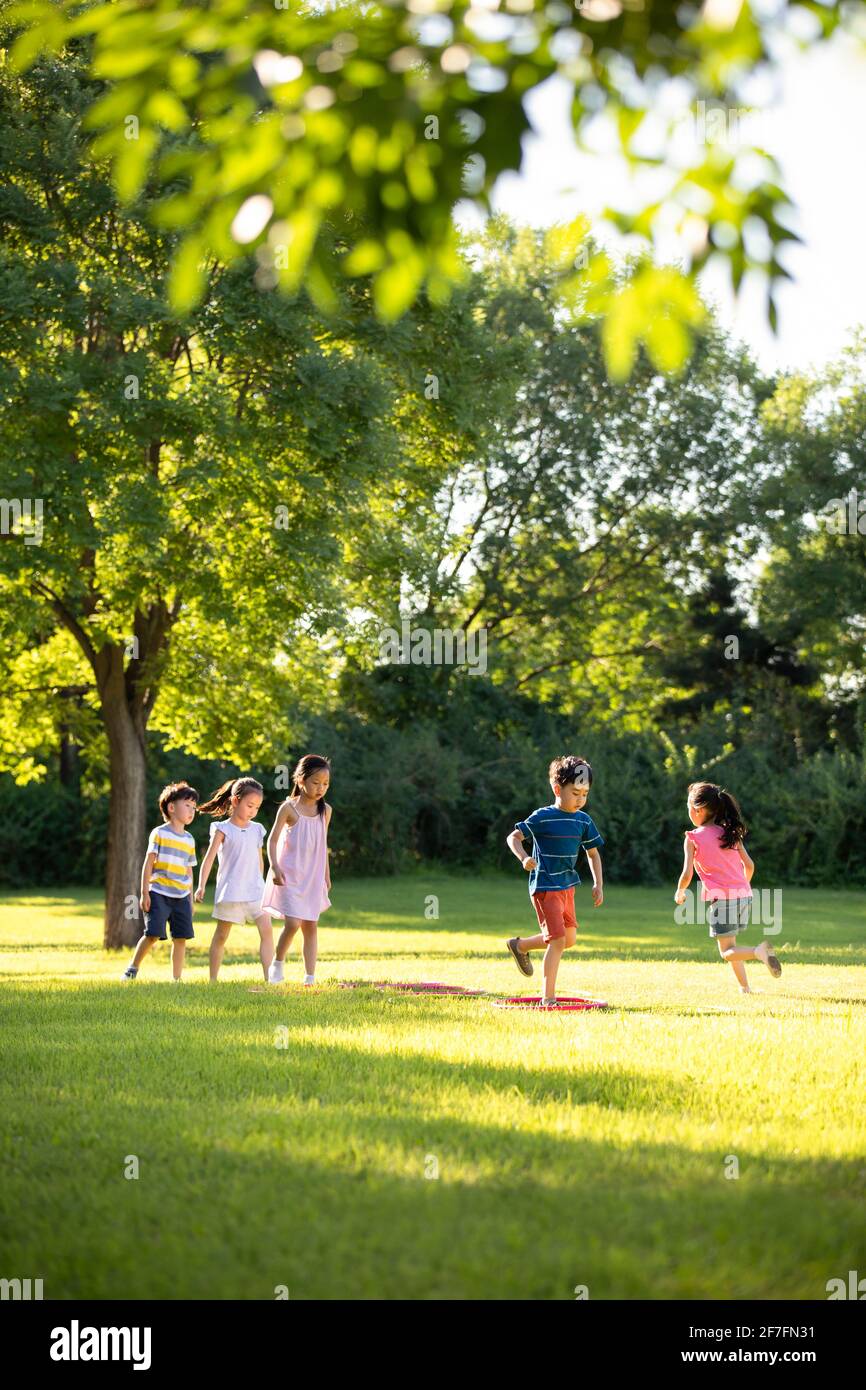 Happy children playing on meadow Stock Photo - Alamy