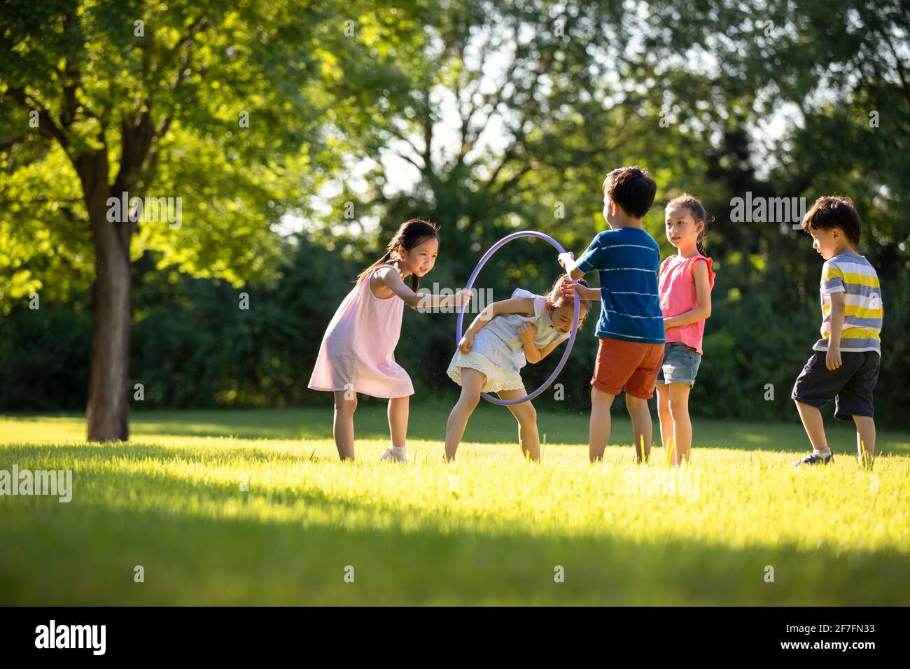Happy children playing on meadow Stock Photo - Alamy