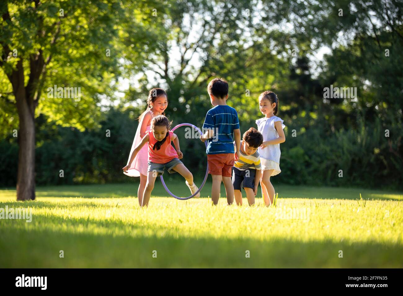 Happy children playing on meadow Stock Photo - Alamy
