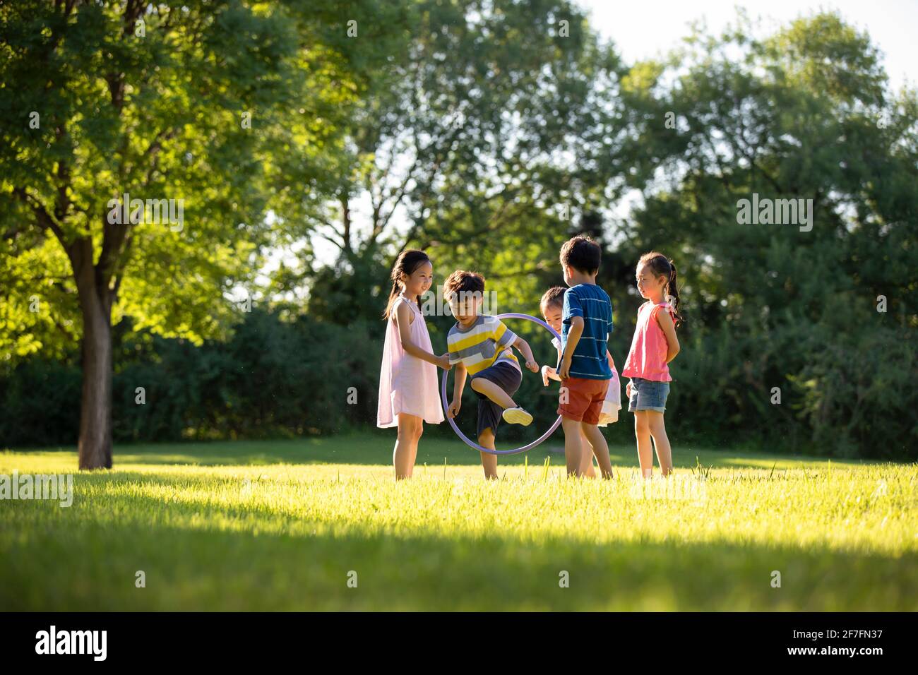 Happy children playing on meadow Stock Photo - Alamy