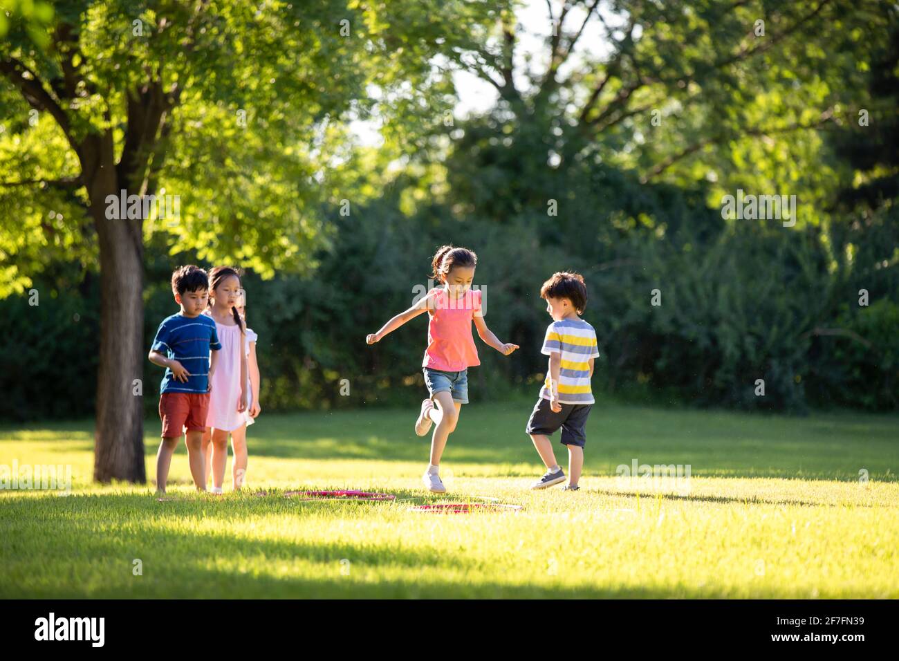 Happy children playing on meadow Stock Photo - Alamy